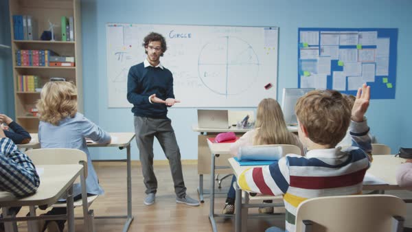 Zoom Out Portrait of Teacher Explaining Lesson to Classroom Full of ...