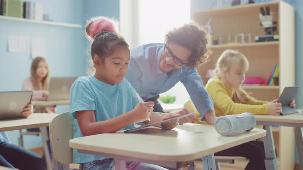Elementary School Computer Science Class: Cute Girl Uses Digital Tablet ...