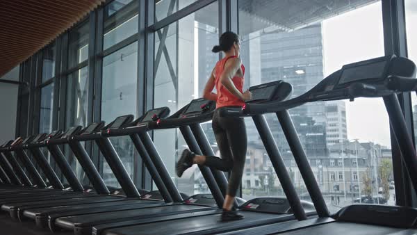 Beautiful Athletic Sports Woman Running on a Treadmill. Energetic Fit ...