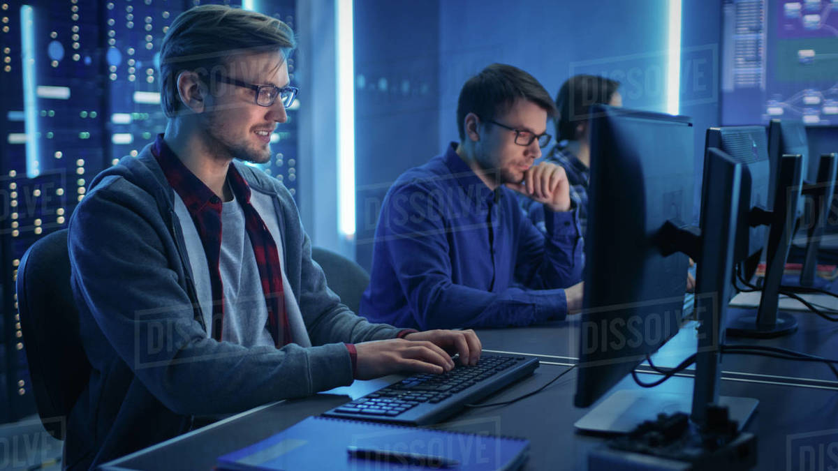 Team of Young IT Programers Working on Desktop Computers in Data Center ...