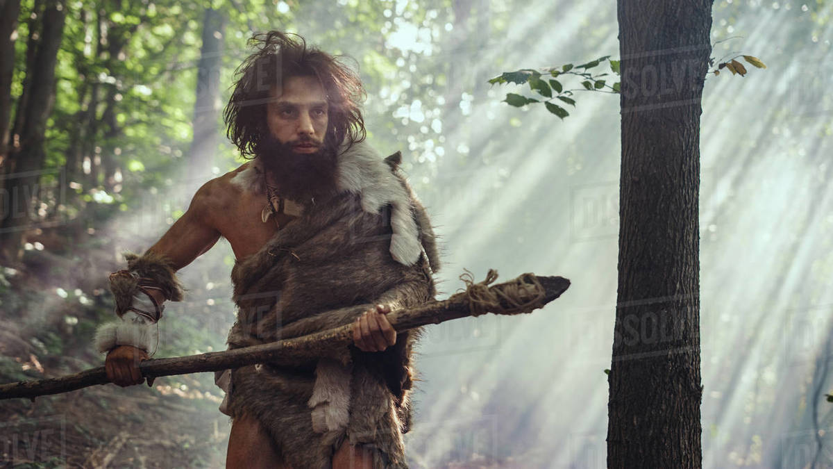 Portrait of Primeval Caveman Wearing Animal Skin and Fur Hunting with a ...