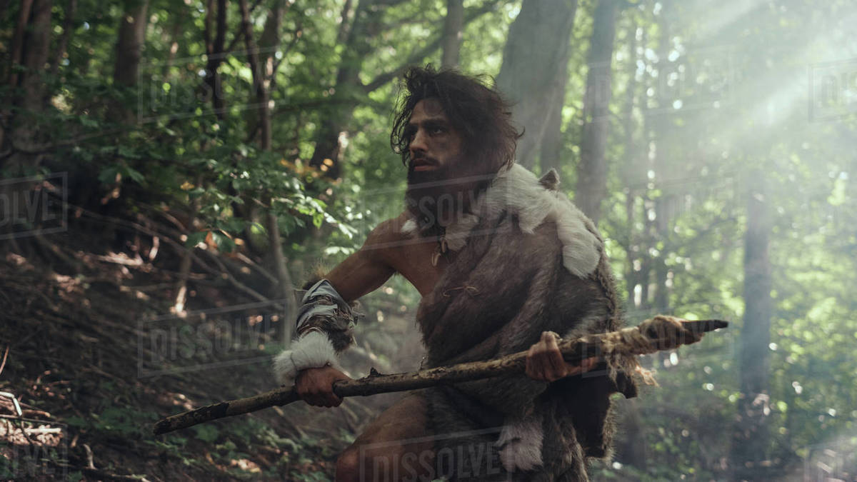Portrait of Primeval Caveman Wearing Animal Skin and Fur Hunting with a ...