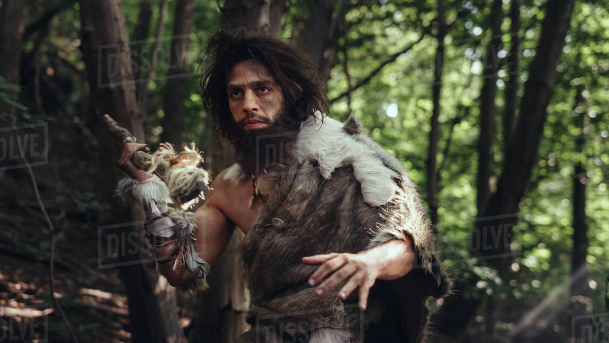 Portrait of Primeval Caveman Wearing Animal Skin and Fur Hunting with a ...