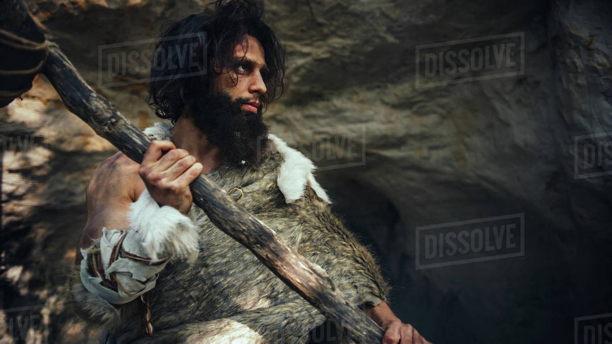 Primeval Caveman Wearing Animal Skin Holds Stone Hammer Comes out of ...