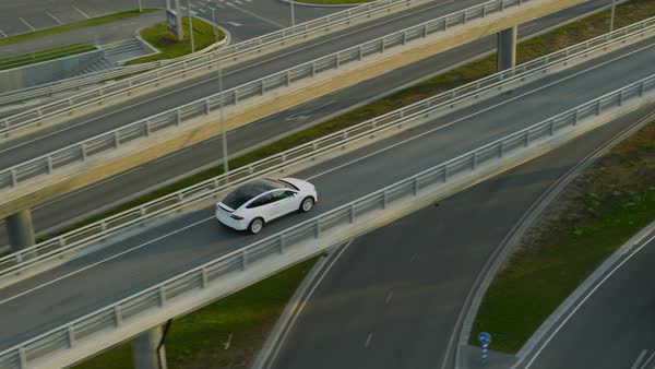 A modern luxury white electric SUV driving on urban highway - Stock ...