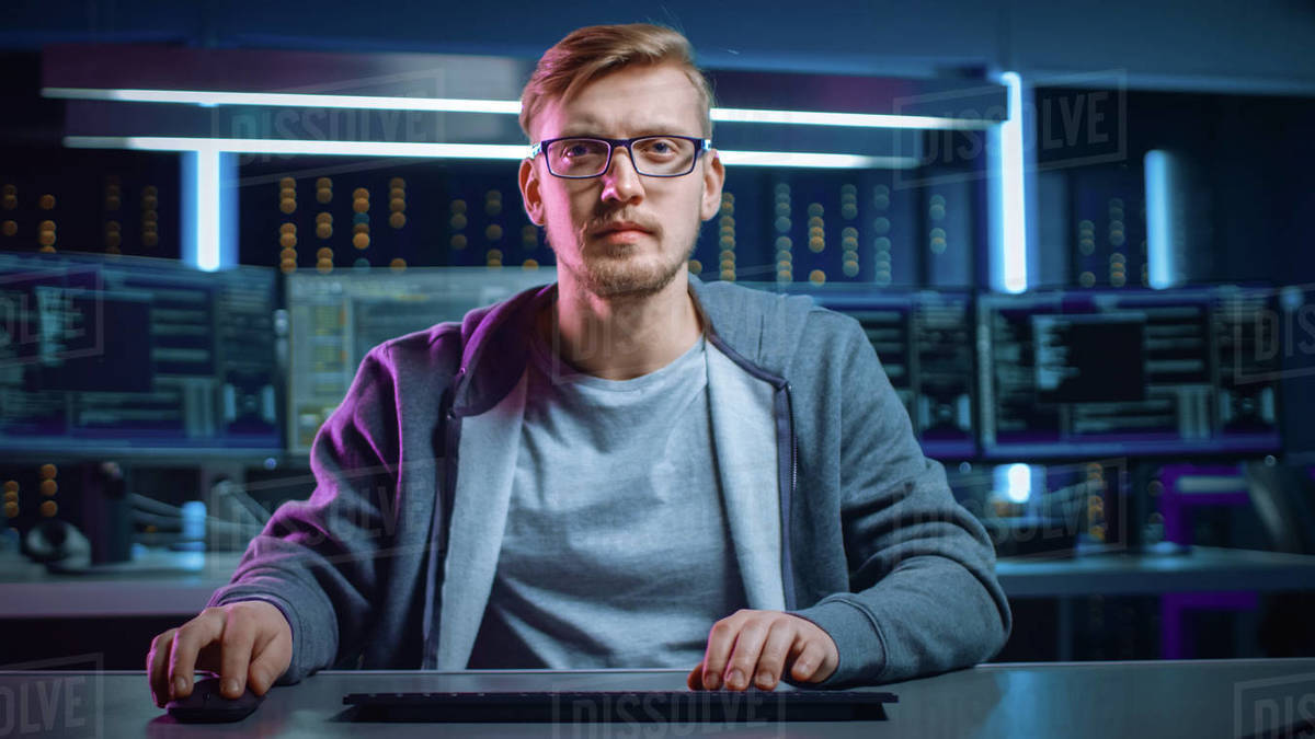 Portrait of Software Developer / Hacker Wearing Glasses Sitting at His ...