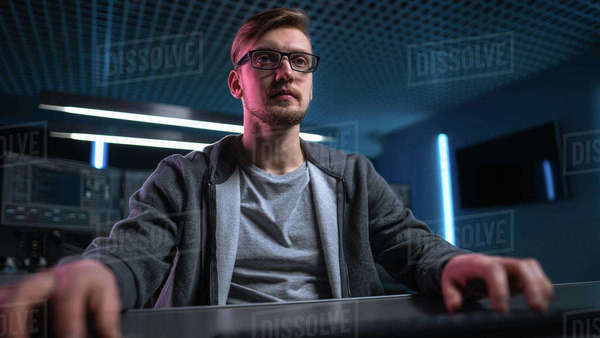 Low Angle Portrait Shot of Software Developer / Hacker Wearing Glasses ...