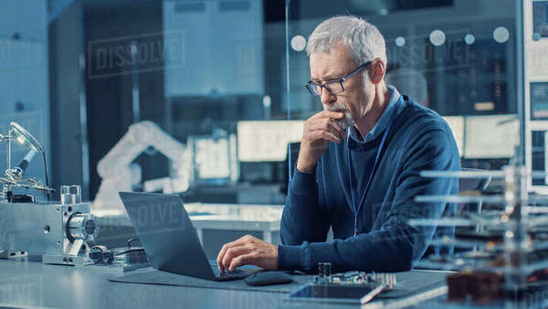 Professional Electronics Design Engineer Wearing Glasses Works on ...