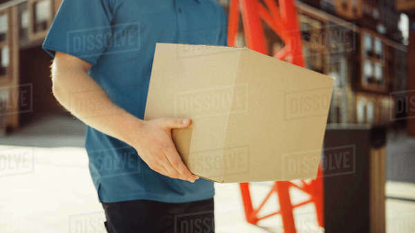 Delivery Man Holds Cardboard Box Package Walks Through Modern Stylish ...