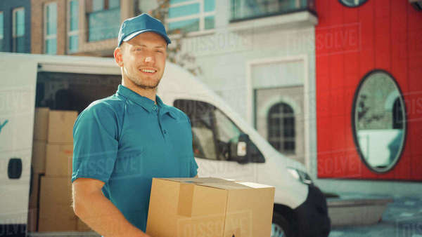 Portrait of Handsome Delivery Man Holds Cardboard Box Package Standing ...