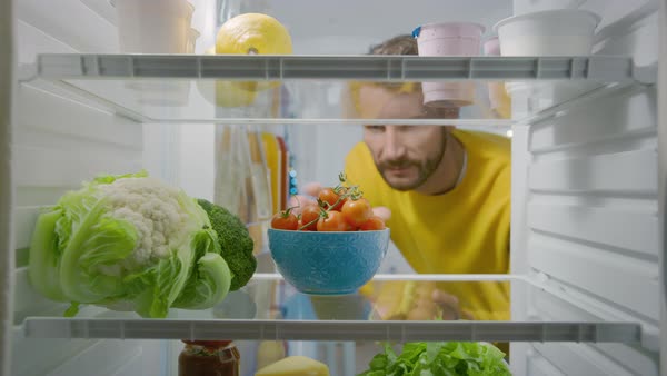 Camera Inside Kitchen Fridge: Handsome Man Opens Fridge Door, Looks ...