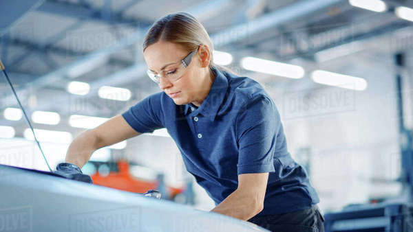 Beautiful Empowering Female Car Mechanic is Working on a Vehicle in a ...