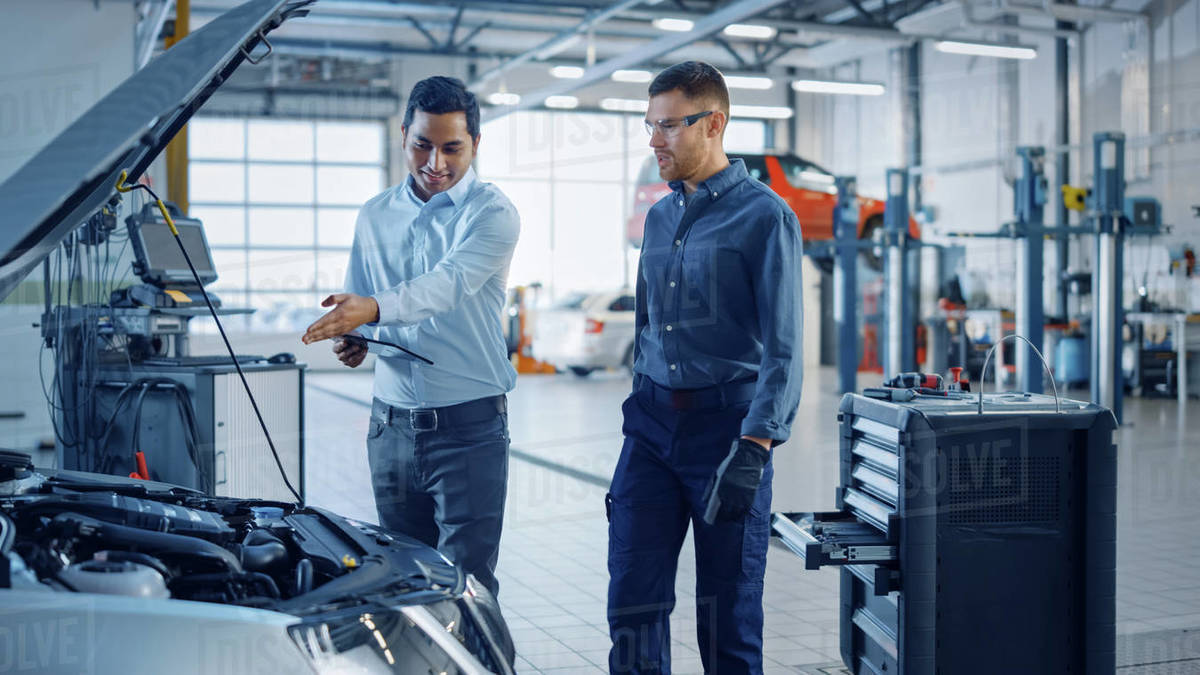 Manager Checks Data on a Tablet and Explains an Engine Breakdown to a ...