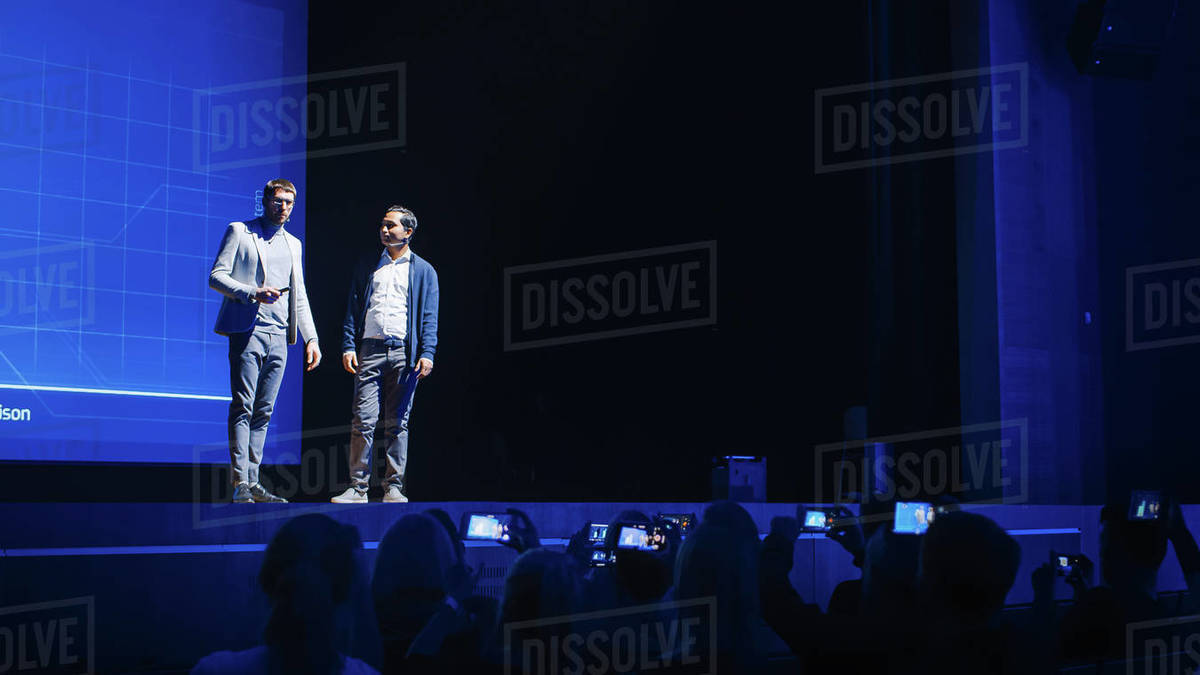 Startup CEO and Chief Developer Stand on Stage and Present New Product ...