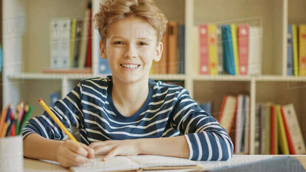 Happy Little Boy Does Homework, Writes Down Useful Information, Looks ...