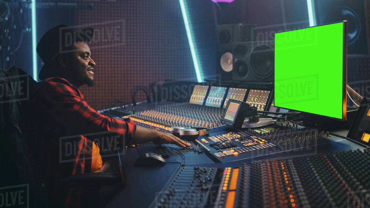 Stylish Audio Engineer / Producer Working in Music Record Studio, Uses ...