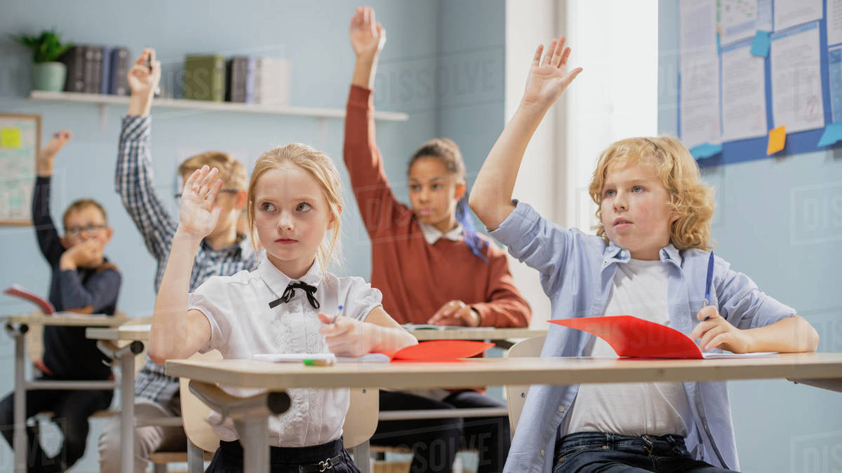 Elementary Classroom of Diverse Children Listening to the Teacher ...