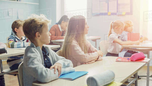Elementary Classroom of Diverse Bright Children Listening Attentively ...