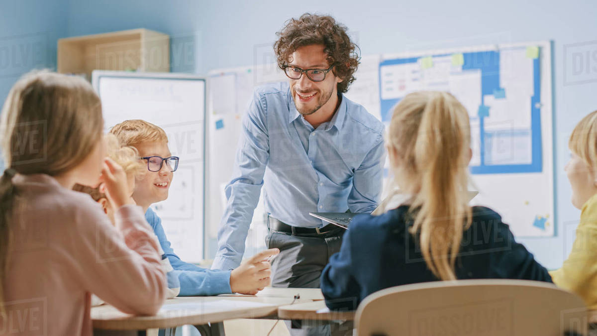 Enthusiastic Teacher Explains Lesson to a Classroom Full of Bright ...