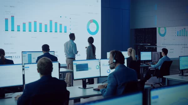 Two Traders Having a Meeting in a Modern Monitoring Office with ...