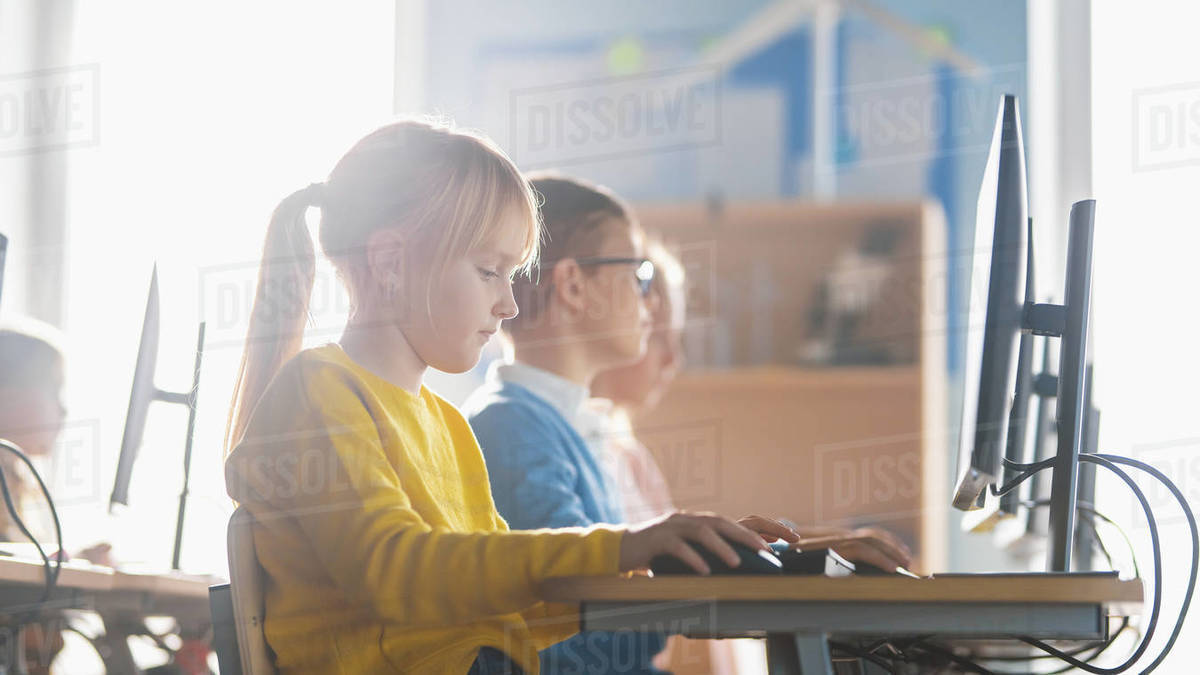 Elementary School Computer Science Classroom: Cute Little Girl Uses ...