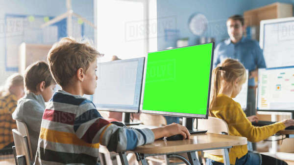 Elementary School Computer Science Classroom: Cute Little Boy Uses ...
