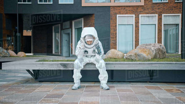 Sad Man in Spacesuit is Sitting on Wooden Bench. Miserable Astronaut ...
