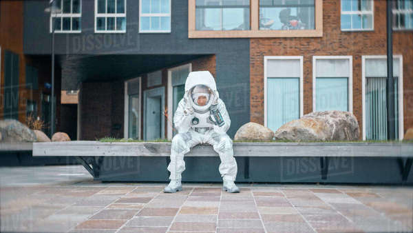 Sad Man in Spacesuit is Sitting on Wooden Bench. Miserable Astronaut ...
