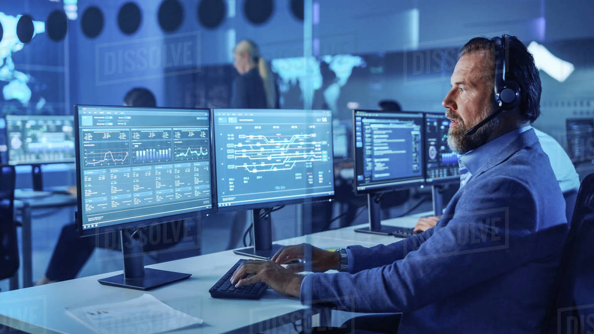 Confident Male Data Scientist Works on Personal Computer Wearing a ...