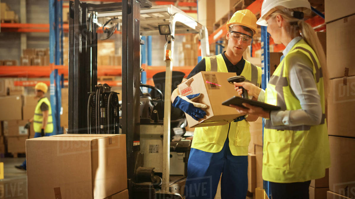 In Warehouse Manager Uses Digital Tablet and Scans Cardboard Boxes for ...
