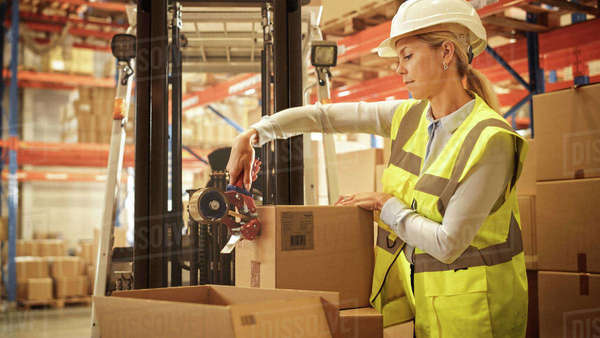 Female Warehouse Inventory Manager Finishes Packing Cardboard Box ...