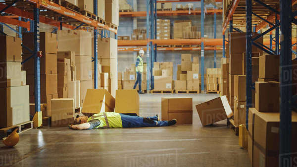 Shot of a Warehouse Worker Has Work Related Accident. He is Falling ...