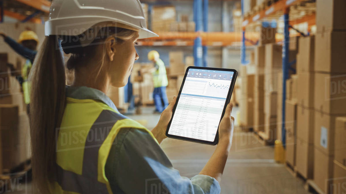 Professional Female Worker Wearing Hard Hat Uses Digital Tablet ...