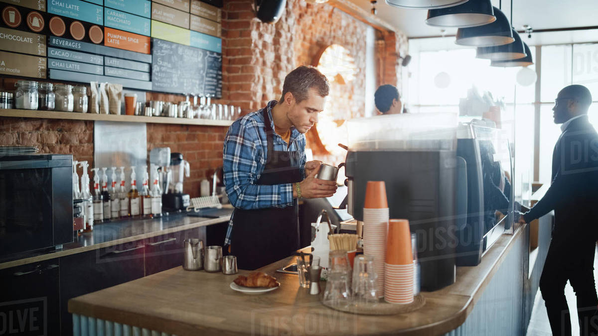 Barista making customer coffee orders in a local coffee shop - Royalty ...