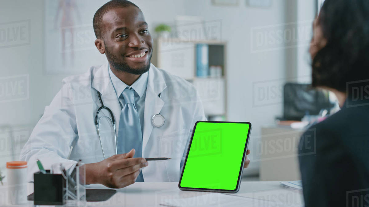 A Medical Doctor Explaining Diagnosis to a Patient on a Computer with ...