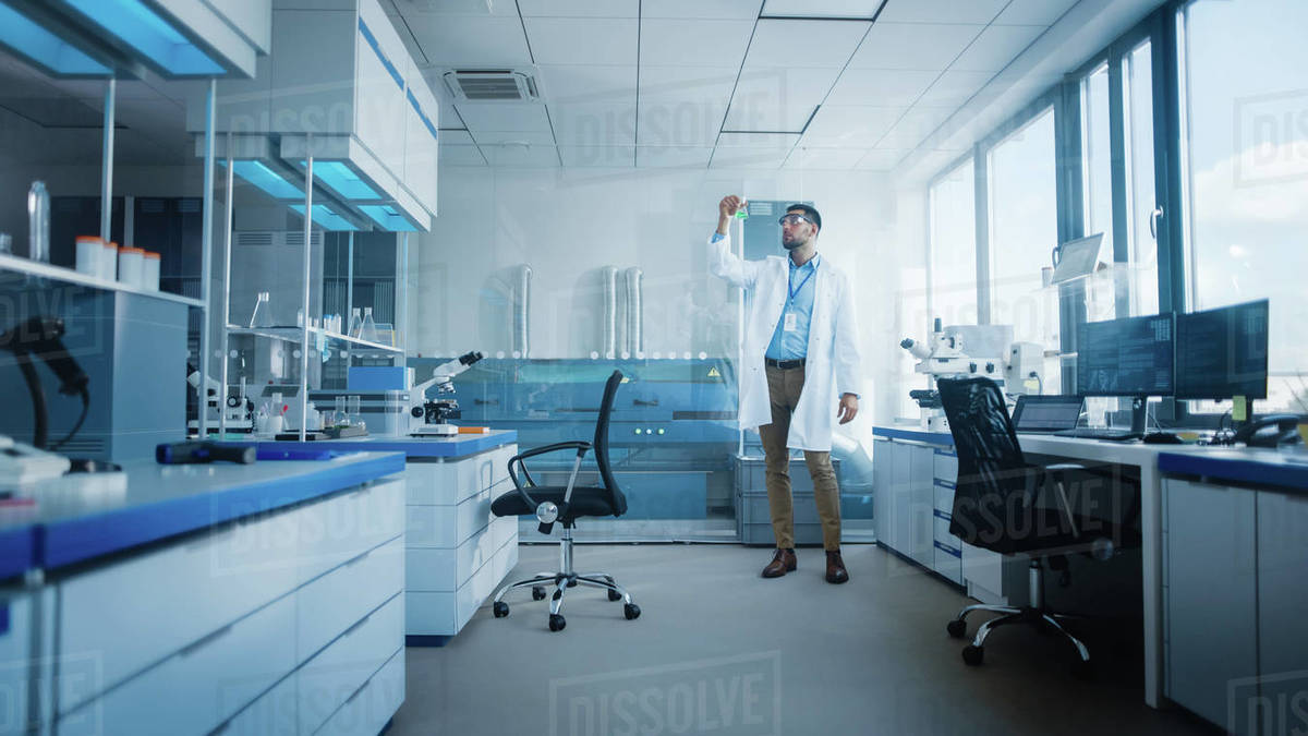 Modern Medical Research Laboratory with Male Scientist Analysing ...