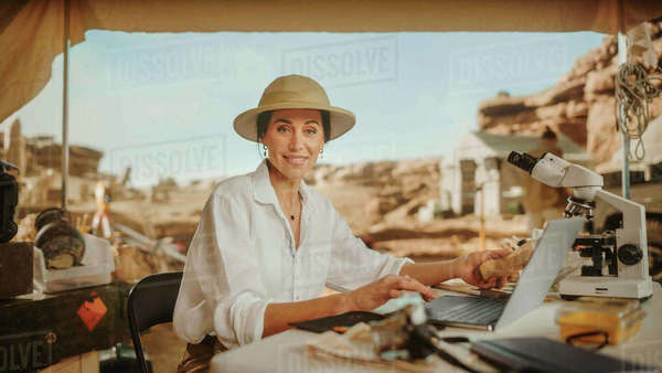 Female Archaeologist Doing Research - Stock Photo - Dissolve