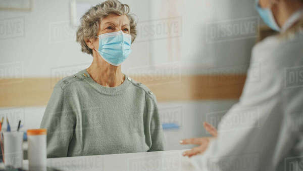 Female Family Doctor is Speaking to a Senior Woman During Consultation ...