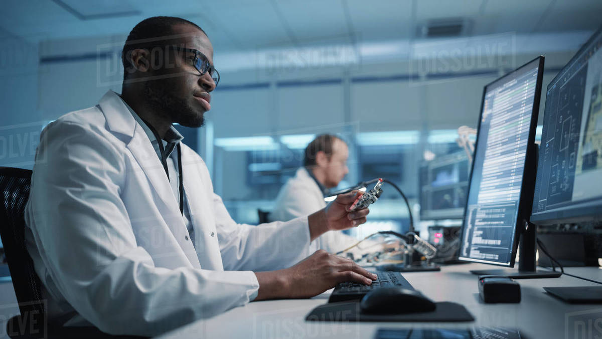 Black Engineer and Diverse Team of Multi-Ethnic Scientists Work on ...