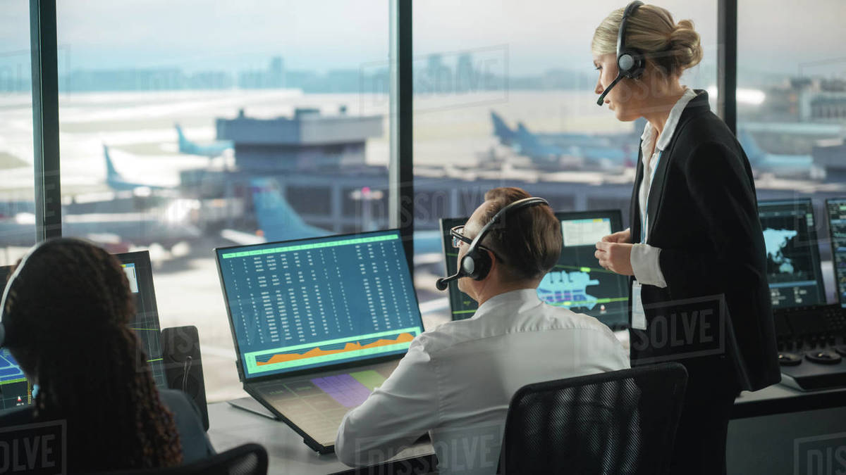 Diverse Air Traffic Control Team Working in a Modern Airport Tower ...