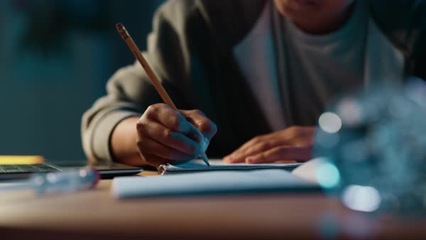 Close up of a Teenage Multiethnic Black Girl Writing Down Homework in a ...