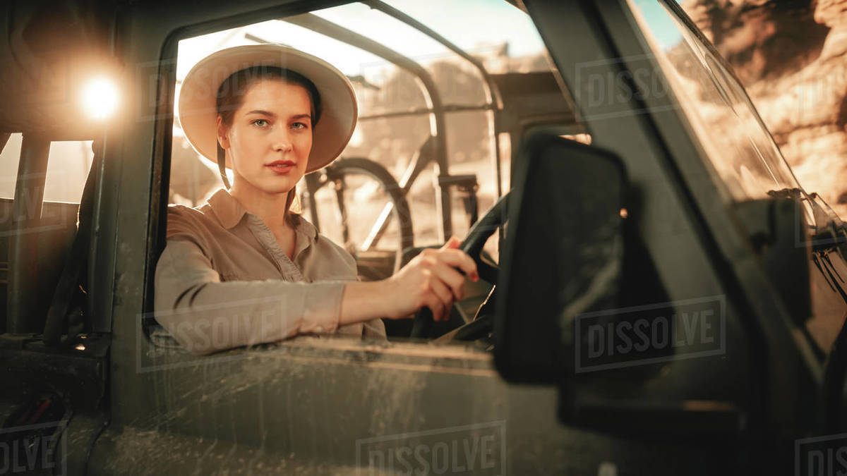 Desert Road Trip: Portrait of Beautiful Female Explorer Looking out of ...