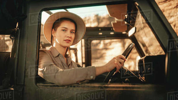 Desert Road Trip: Portrait of Beautiful Female Explorer Looking out of ...