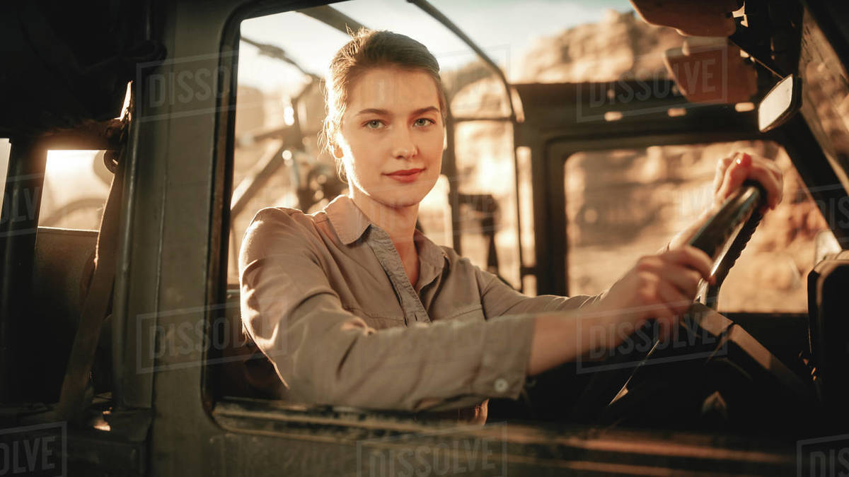 Desert Road Trip: Portrait of Beautiful Female Explorer Looking out of ...