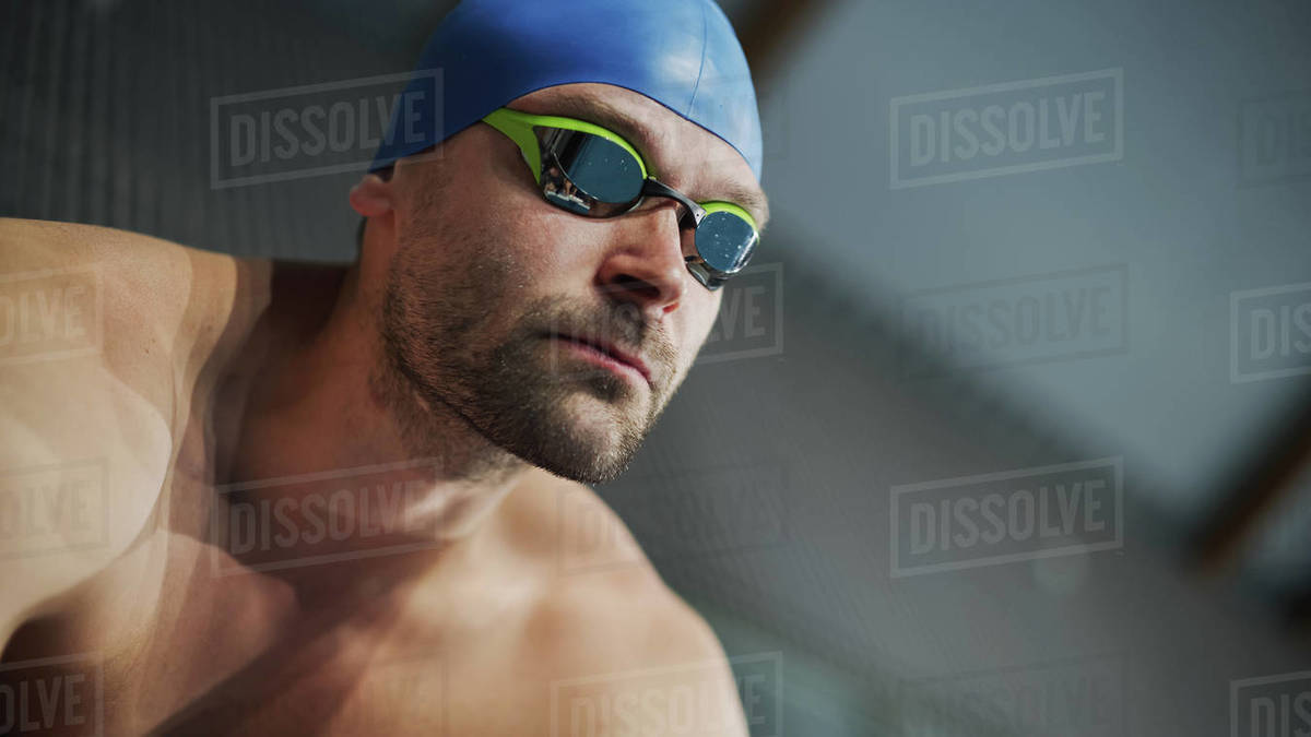 Handsome Professional Male Swimmer in Swimming Pool, Wearing Cap and ...