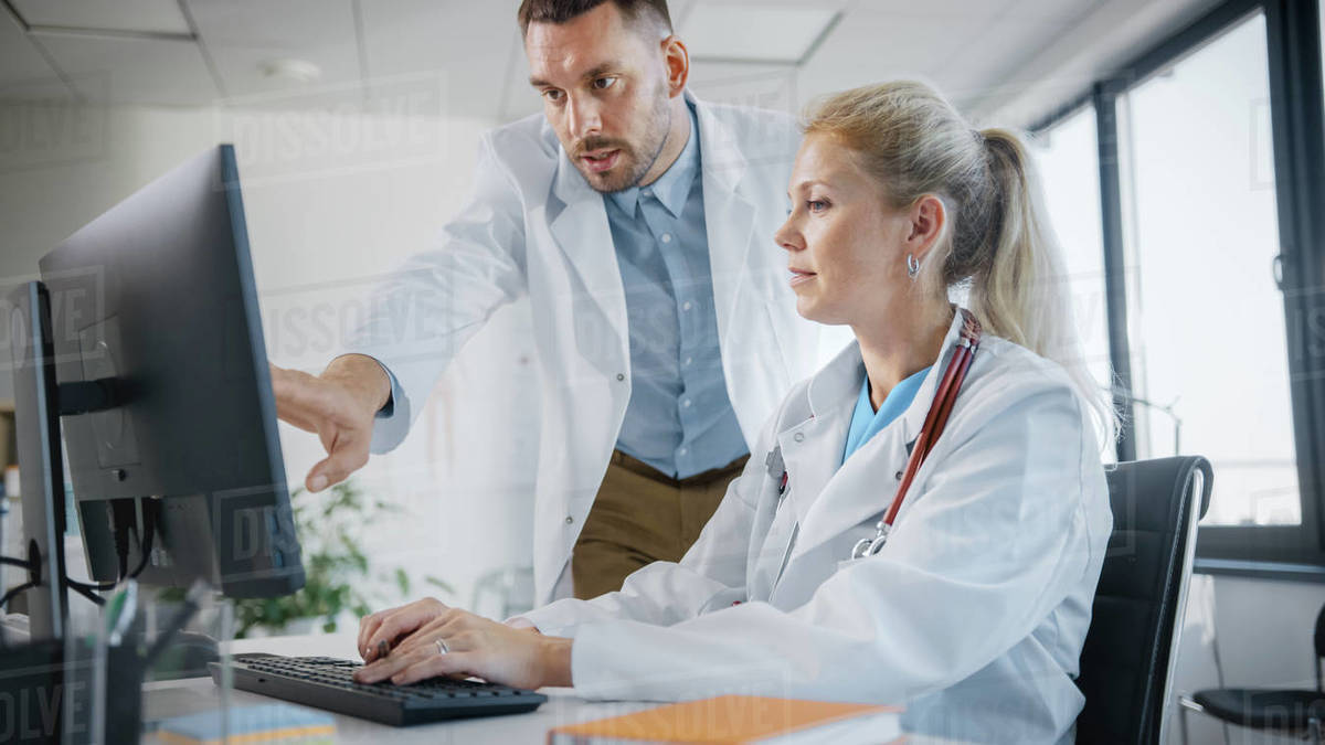 Hospital Medical Doctor's Office: Two Professional Physicians Talking ...