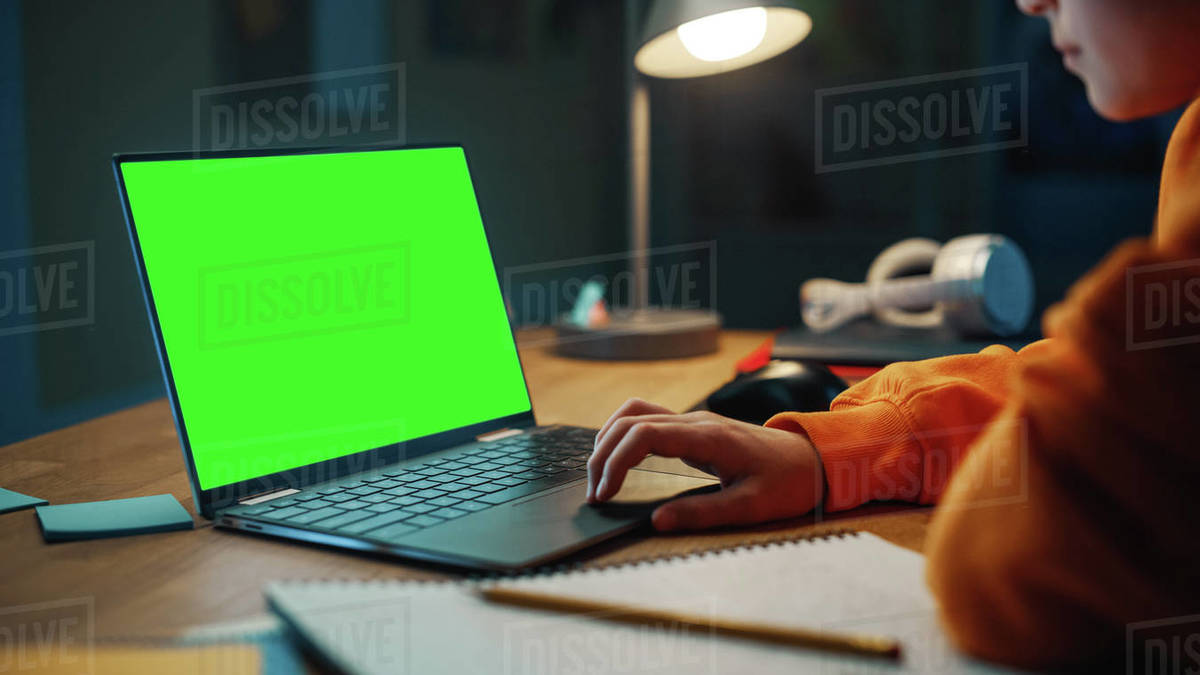 Young Boy Researching Homework on Laptop Computer with Green Screen ...