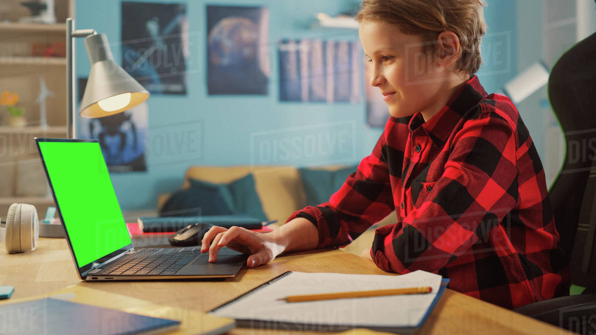 Young Boy Researching Homework on Laptop Computer with Green Chroma Key ...