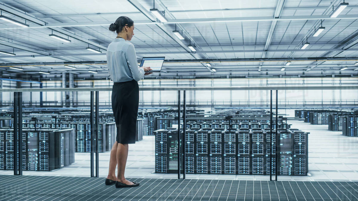 Data Center Engineer Using Laptop Computer - Stock Photo - Dissolve