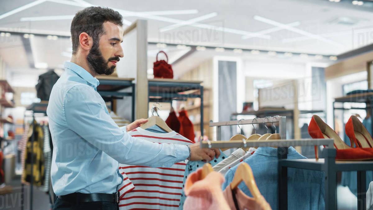 Male Clothing Store Assistant Works in Fashionable Shopping Mall ...